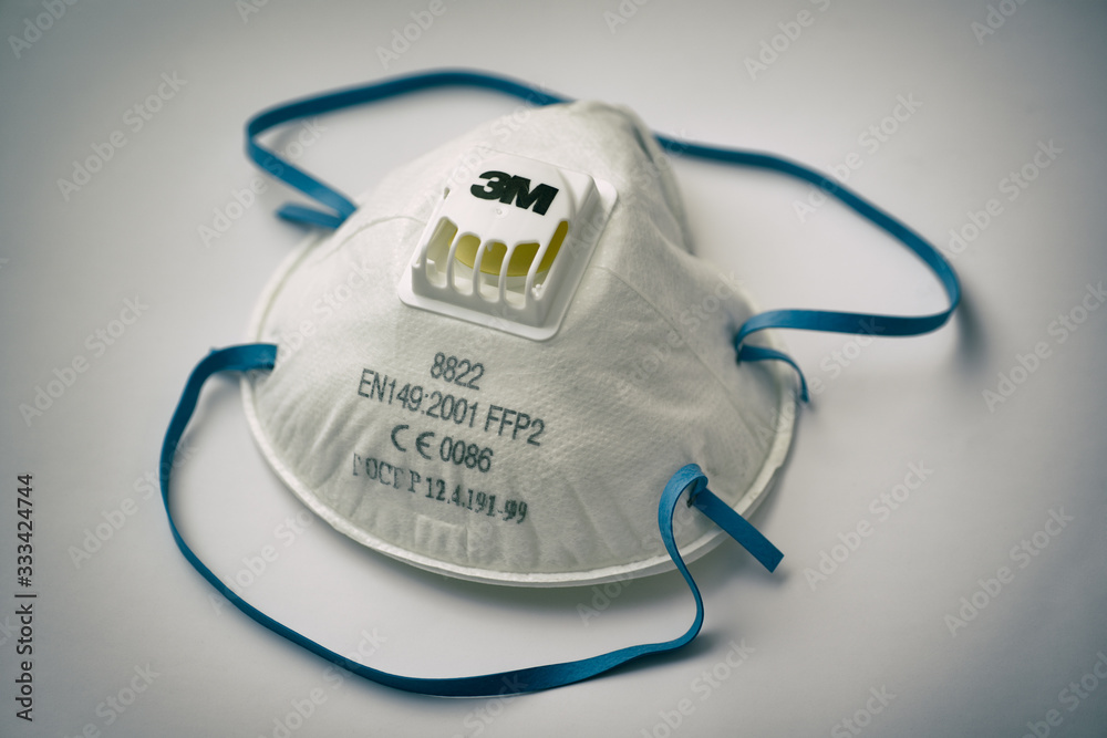 3M brand FFP2 class certified filter mask lying on white background ...
