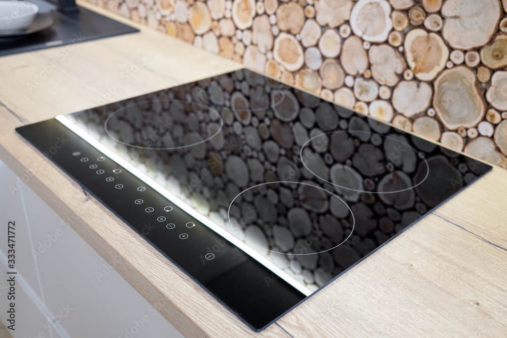 Modern kitchen interior with black induction stove, cooker, hob or ...