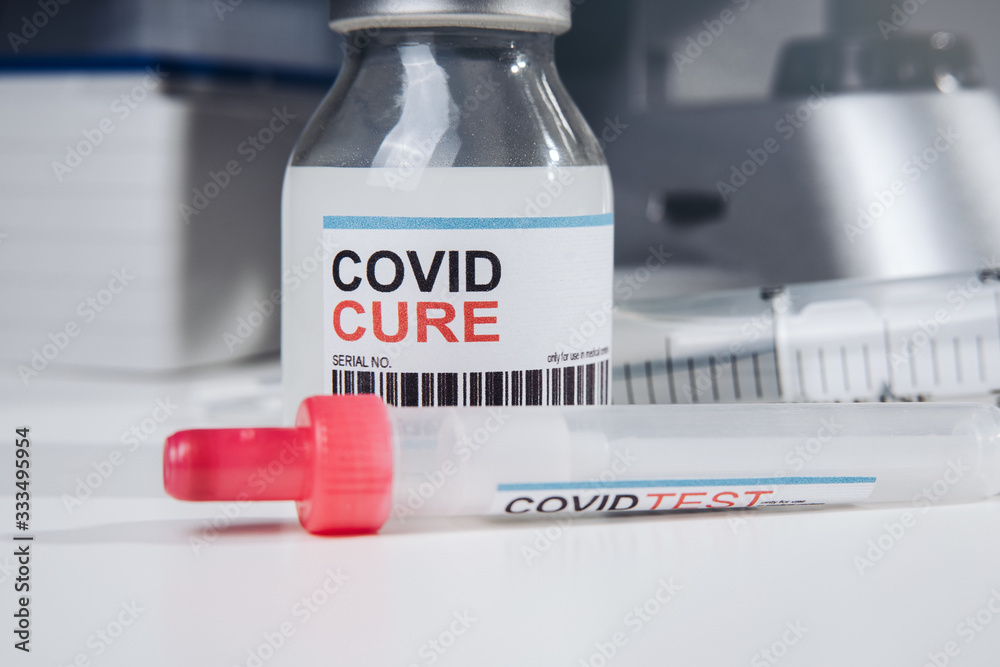Coronavirus COVID-19 vaccine glass bottle in the laboratory. Cure for ...