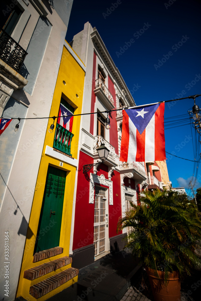 The Puerto Rican flag flies on a sunny day in the colorful Viejo San ...