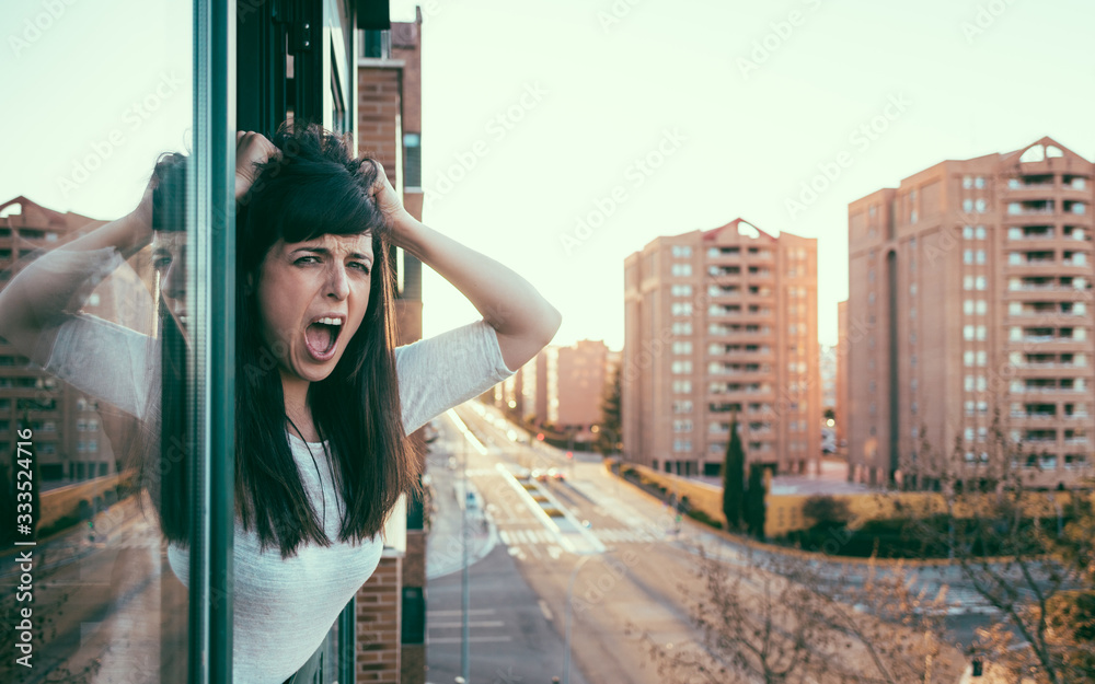 Desperate bored woman peeks out the window during quarantine over covid ...