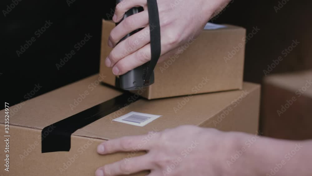 Delivery man scanning boxes with barcode scanner Stock Video | Adobe Stock