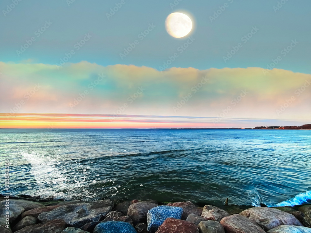 sunset and moon on sea ,pink blue clouds on horizon ,emerald green sea ...