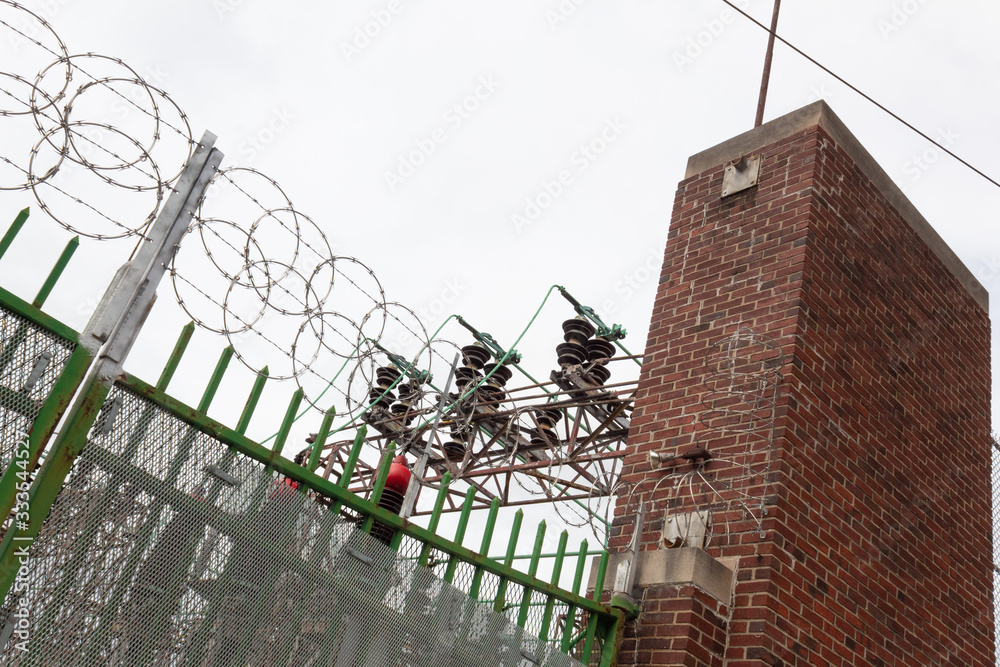 Angled view of power substation enclosure with old brick and wrought ...