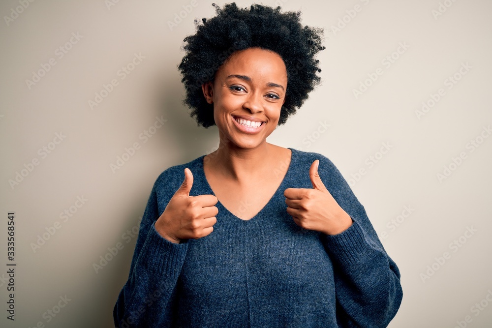 Young beautiful African American afro woman with curly hair wearing ...