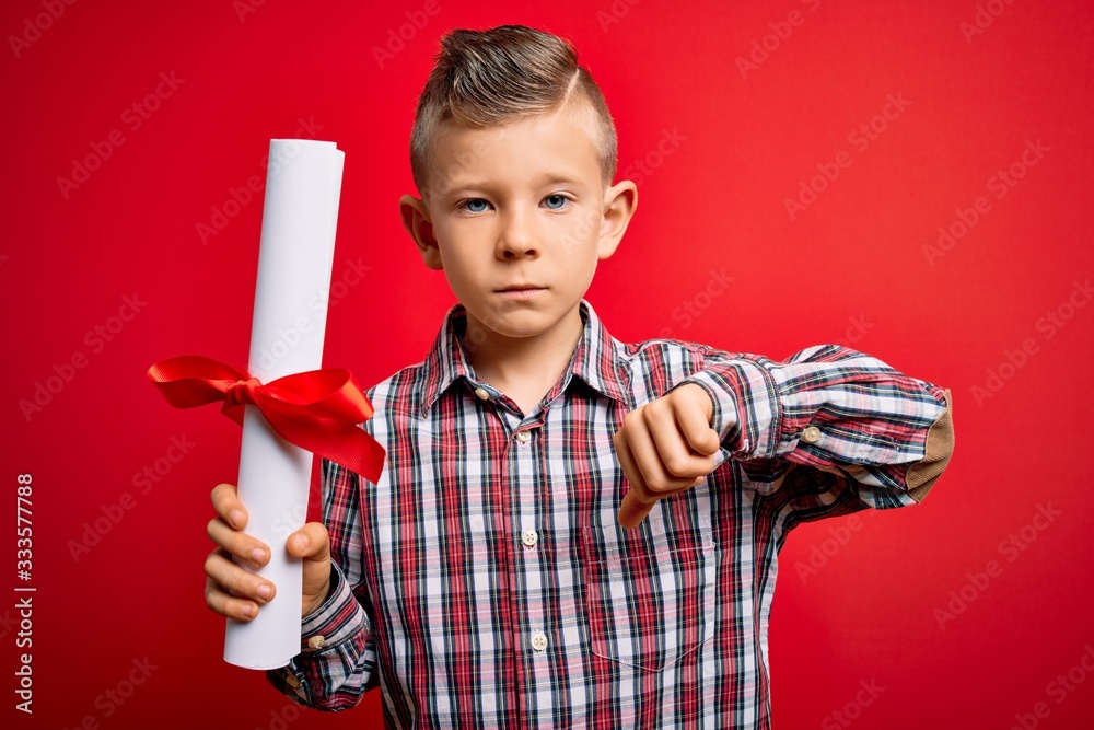 Young little caucasian student kid holding school degree over red ...