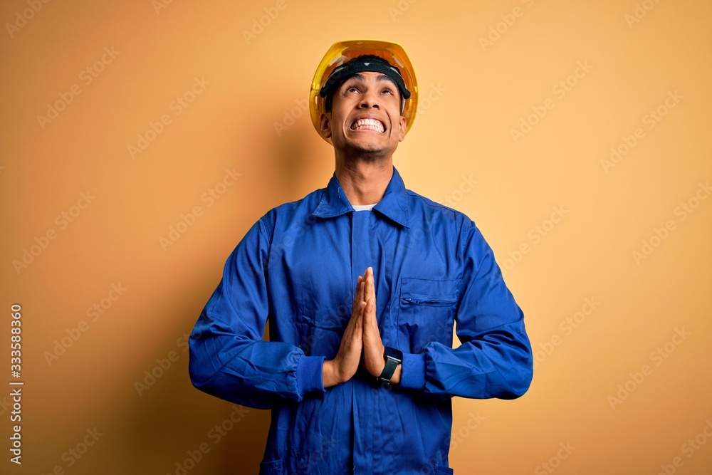 Young handsome african american worker man wearing blue uniform and ...