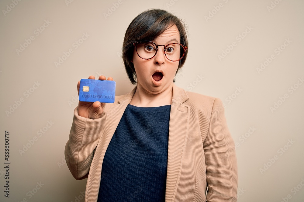 Young down syndrome business woman holding credit card as customer ...