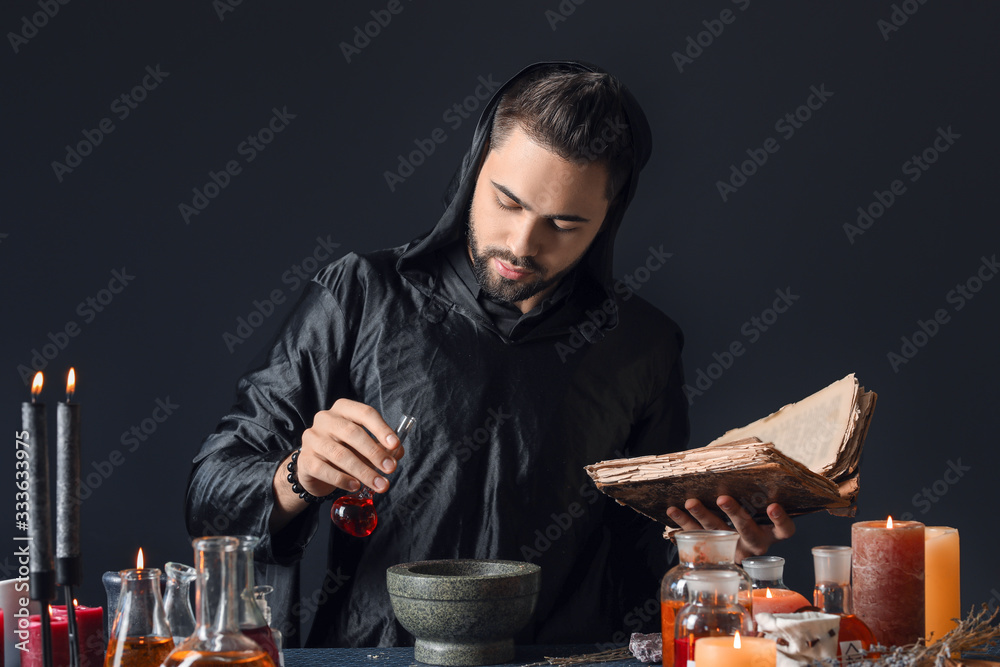 Male alchemist making potion on dark background Stock Photo | Adobe Stock