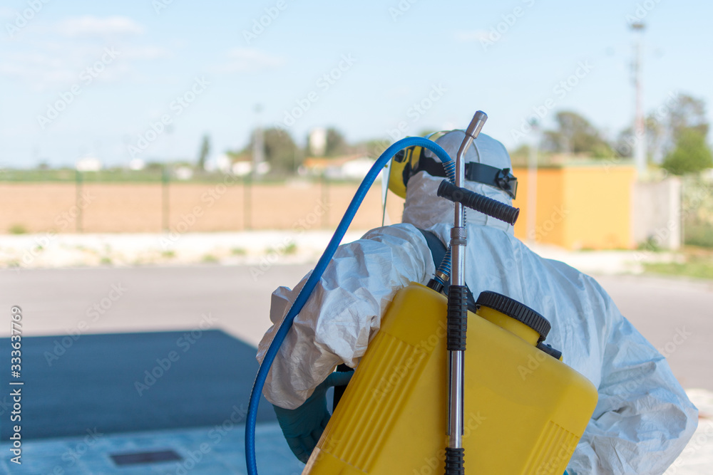 Wearing an NBC personal protective equipment ppe suit, gloves, mask ...