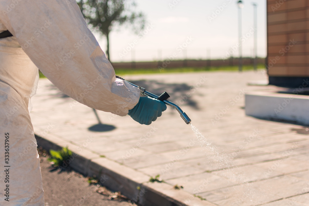Hand, arm and spear. Man wearing an NBC personal protective equipment ...