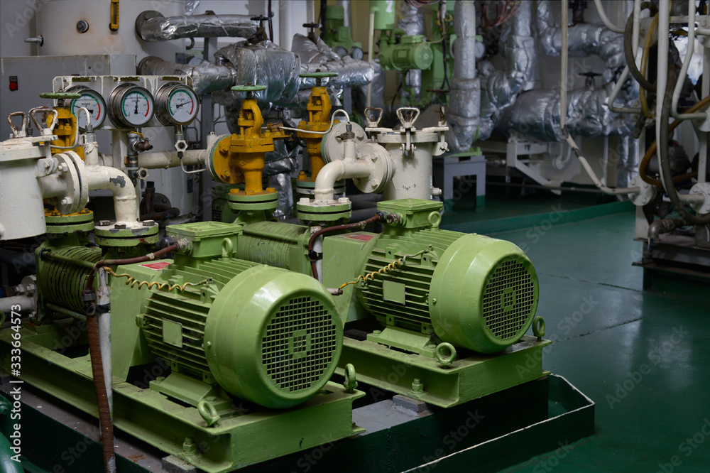 Engine room interior of a big ocean going ship with gauges, electrical ...