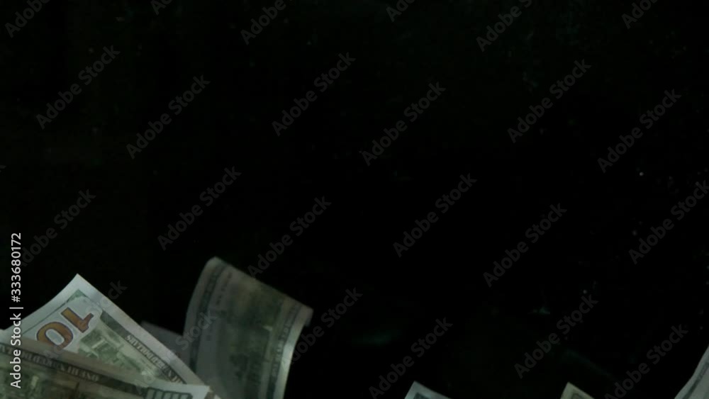 Falling flying american canadian dollar banknotes on a black background ...