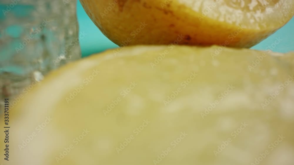 A 4K tilting shot of some cut up lemons on a blue background. Cut up ...