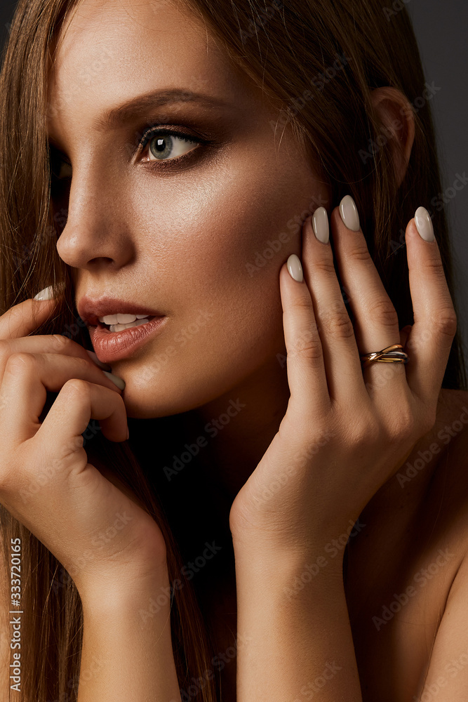 Portrait shot of a lady with a tricolour rolling ring on her middle ...