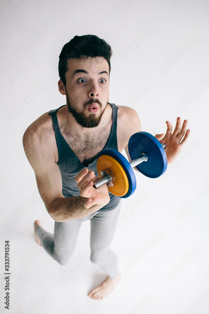 Skinny man training his bicep muscle. Guy lifting one dumbbell. young ...