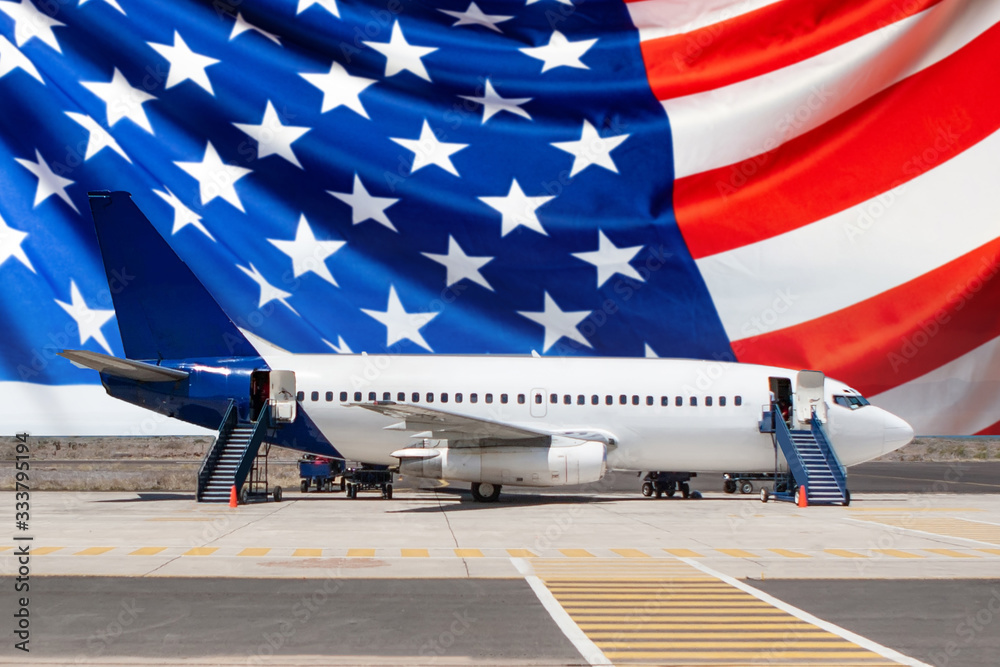 Airplane on the background of the USA flag. Concept - Air Travel in the ...