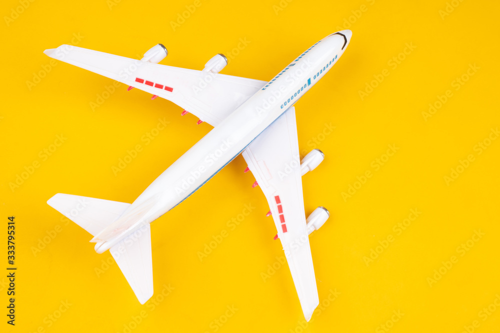 Airliner. Toy plane on a yellow background. Concept airline. Model of a ...