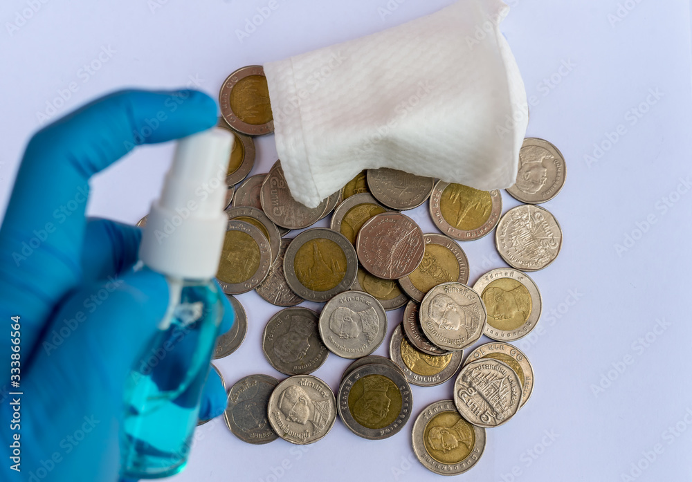 Alcohol sanitizer spray and wet wipe with Thai baht coins or Money thai ...