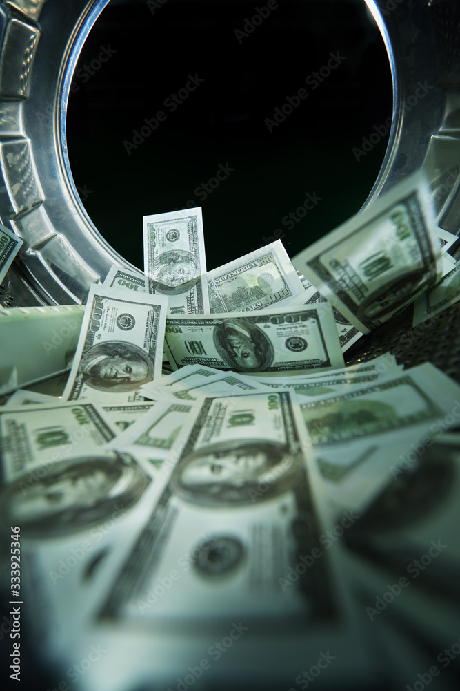 Washing banknotes in machine, money laundering, financial fraud concept ...
