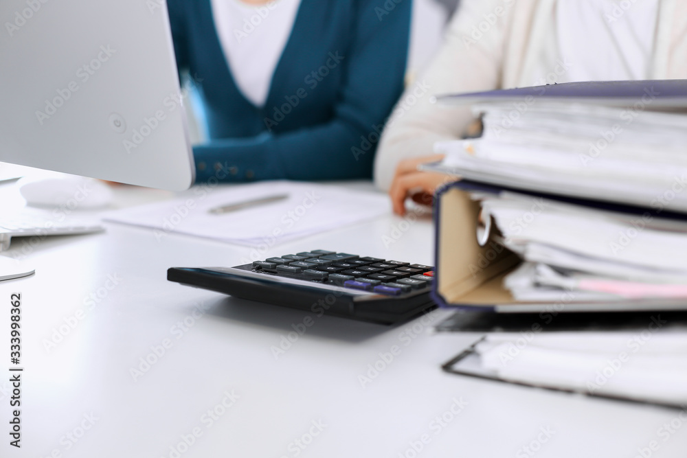 Accountant checking financial statement or counting by calculator ...