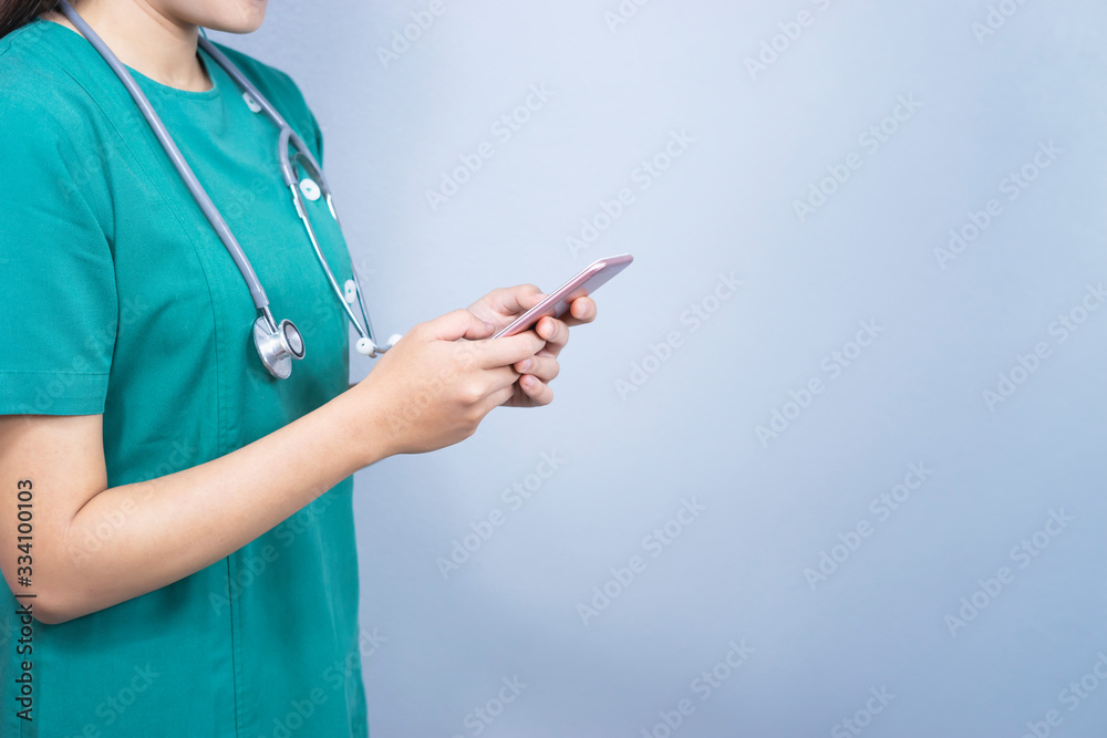 isolated close up body shot of female doctor holding a smart phone with ...