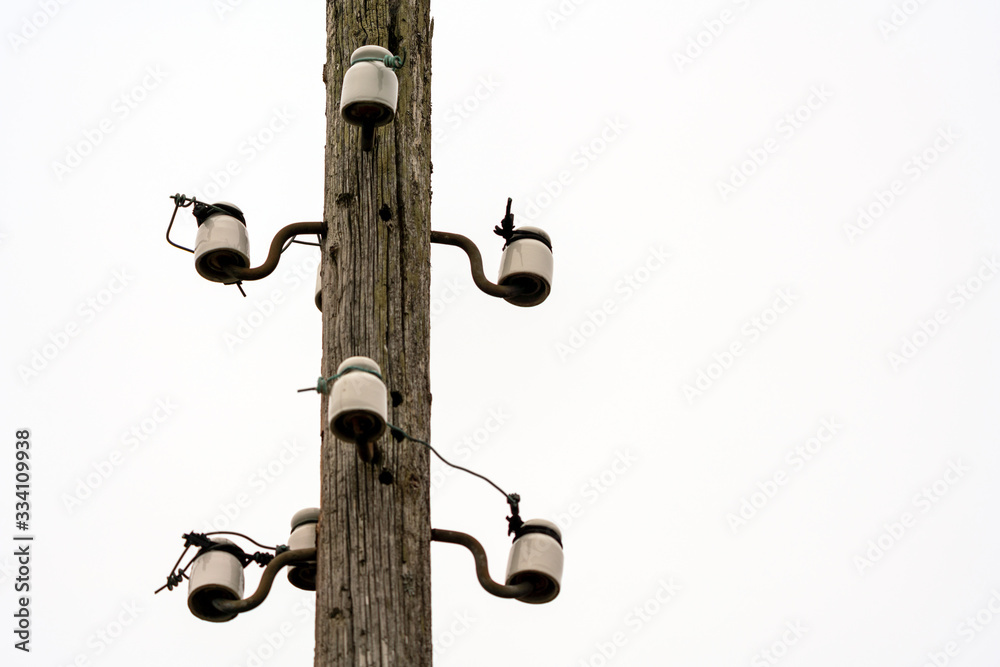 old and wooden electrical telephone pole isolated on white background ...