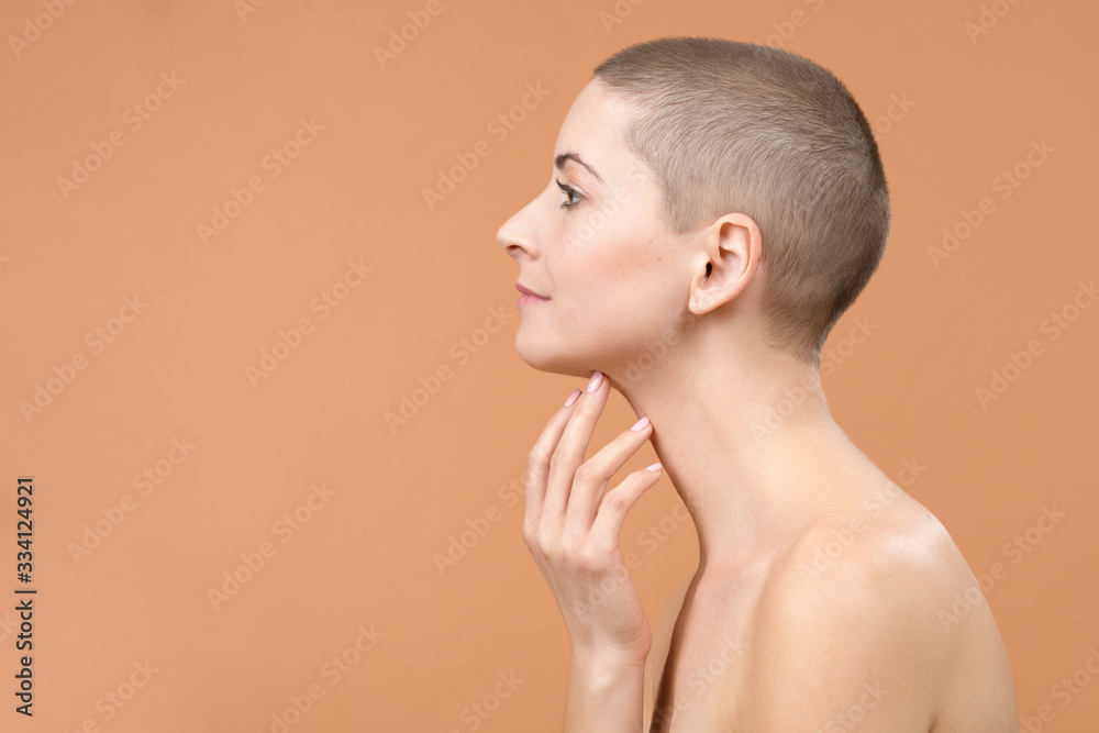 Profile of an attractive mid adult woman looking at herself in the ...