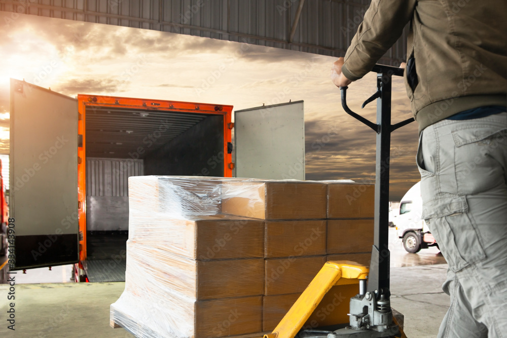 Workers Unloading Packaging Boxes on Pallets into The Cargo Container ...