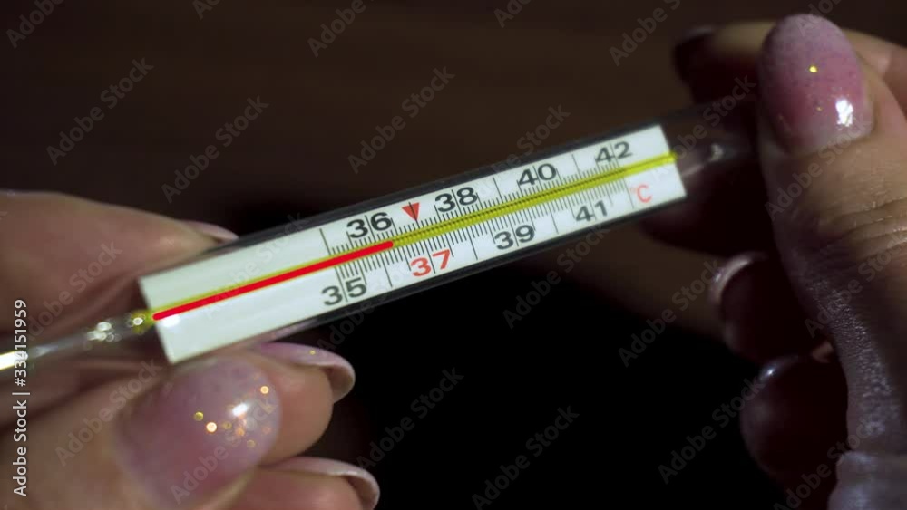 Glass medical thermometer on woman hands using animation shows rising ...