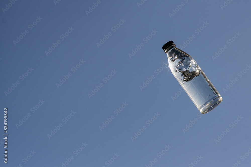 Transparent plastic bottle with water and air bubbles floating in the ...