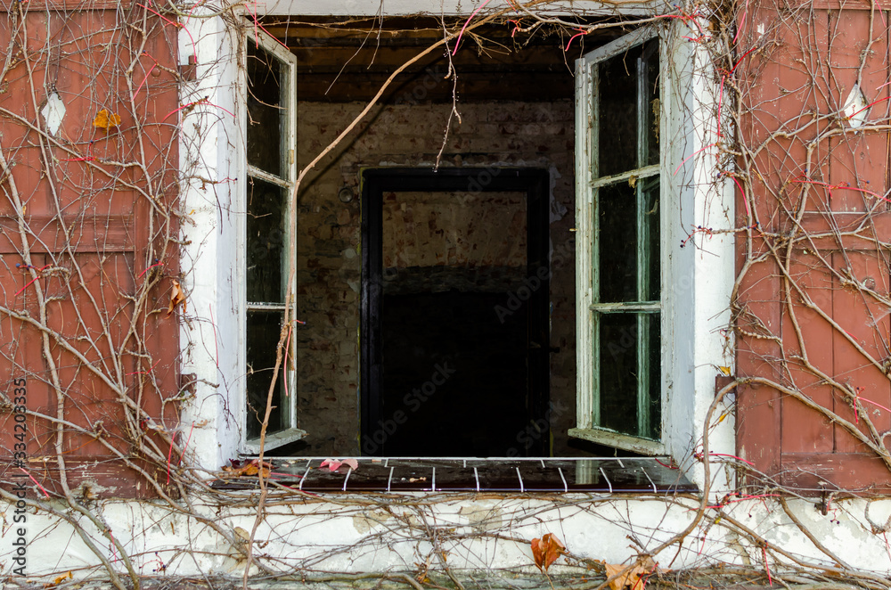 Outside View of old wooden window open and brick wall of ruined house ...