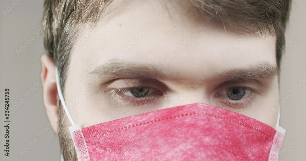 Face touch - coronavirus concept. Man in mask touching his eye - risk ...