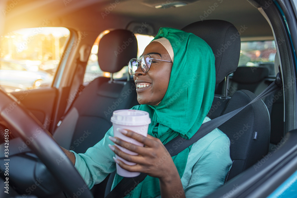 Smiling black muslim woman driving her vehicle. Beautiful Arab Muslim ...