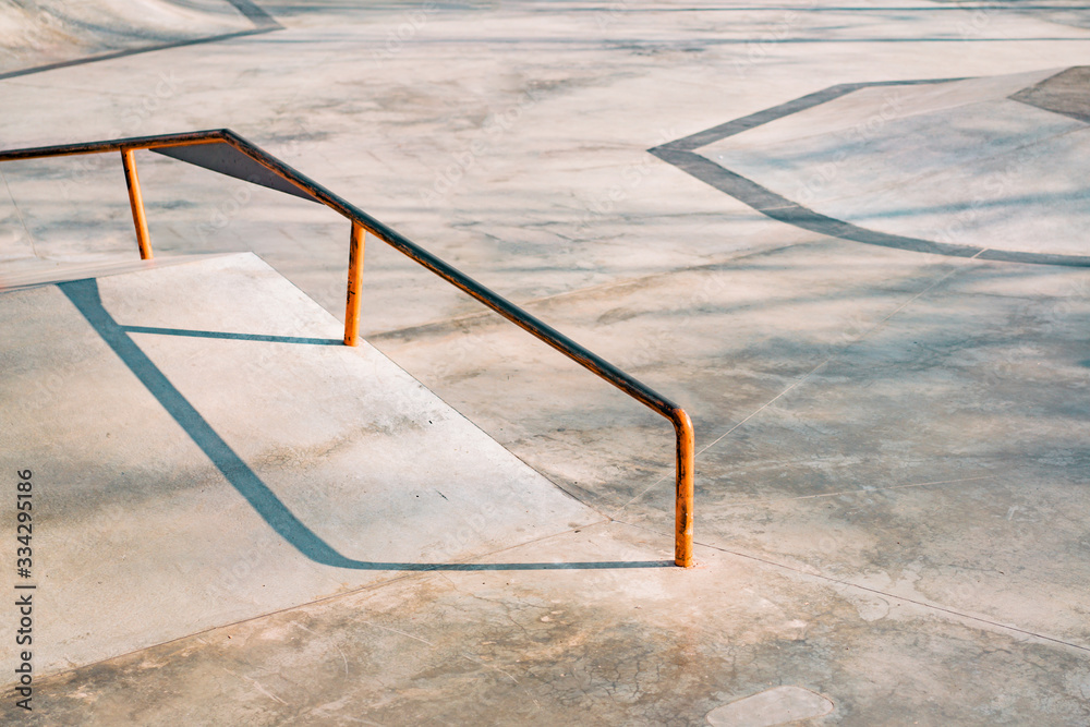 Rail obstacle for skateboarders with slide. Concrete outdoor skate park ...
