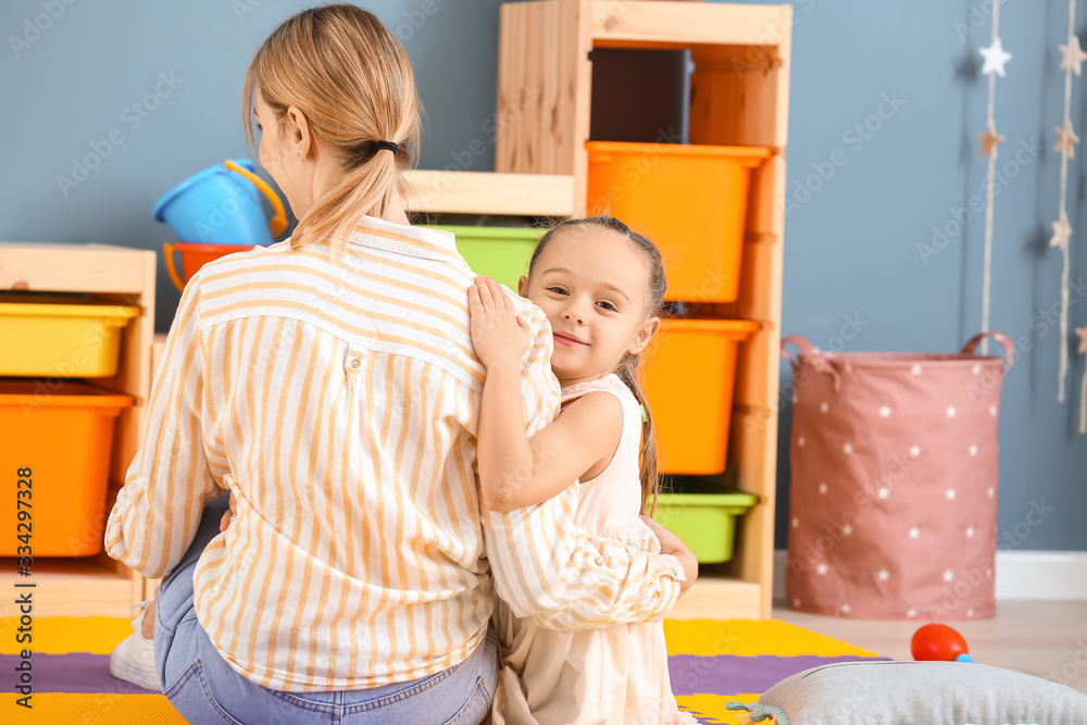 Nanny and cute little girl at home Stock Photo | Adobe Stock