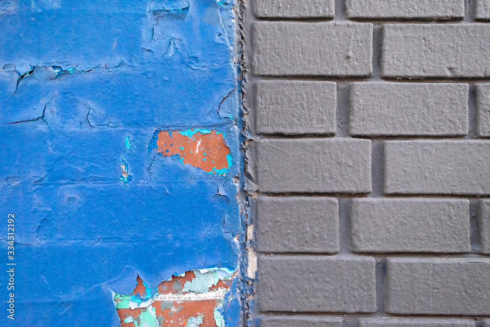 Two brick walls joined together.One is royal blue in color with paint ...