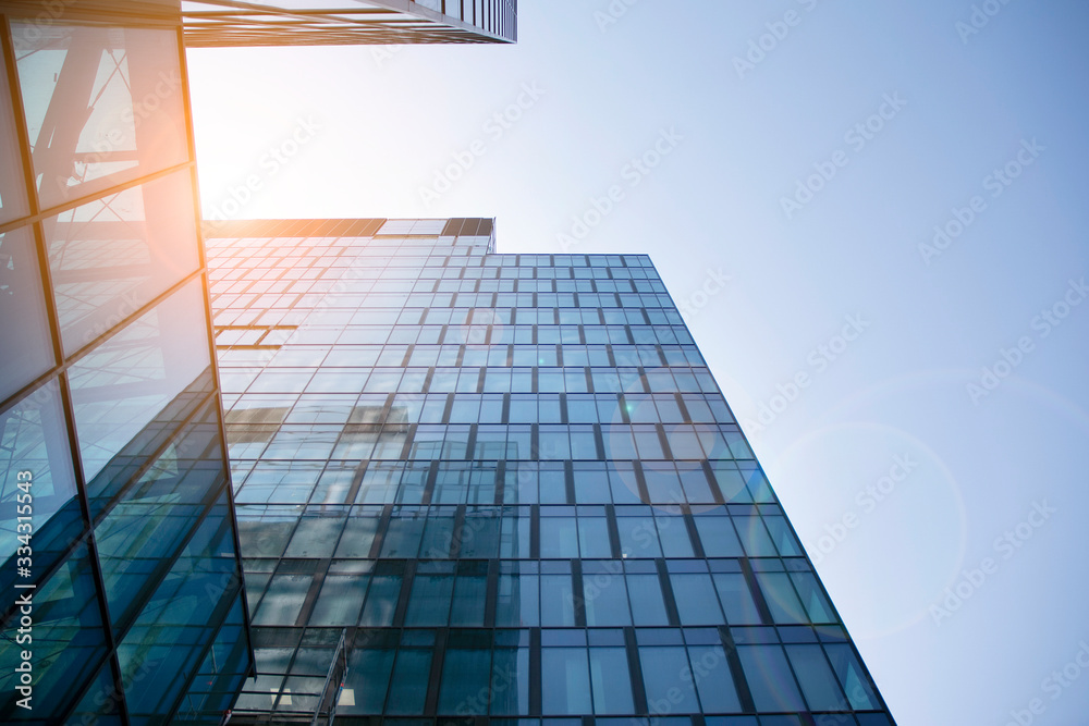 Skyscraper, modern building in the city with sunlight. Glass wall of an ...