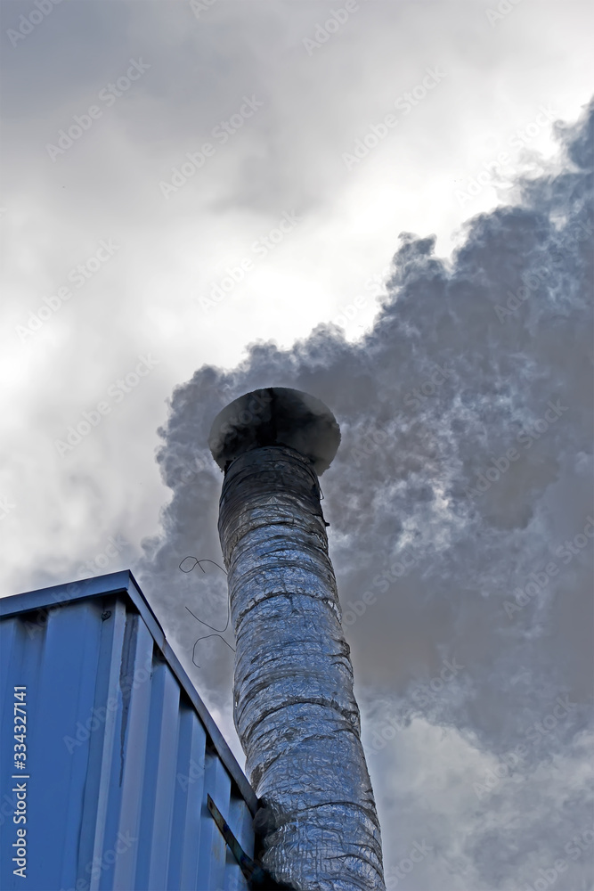black smog from high industrial pipe with silver insolation on blue sky ...