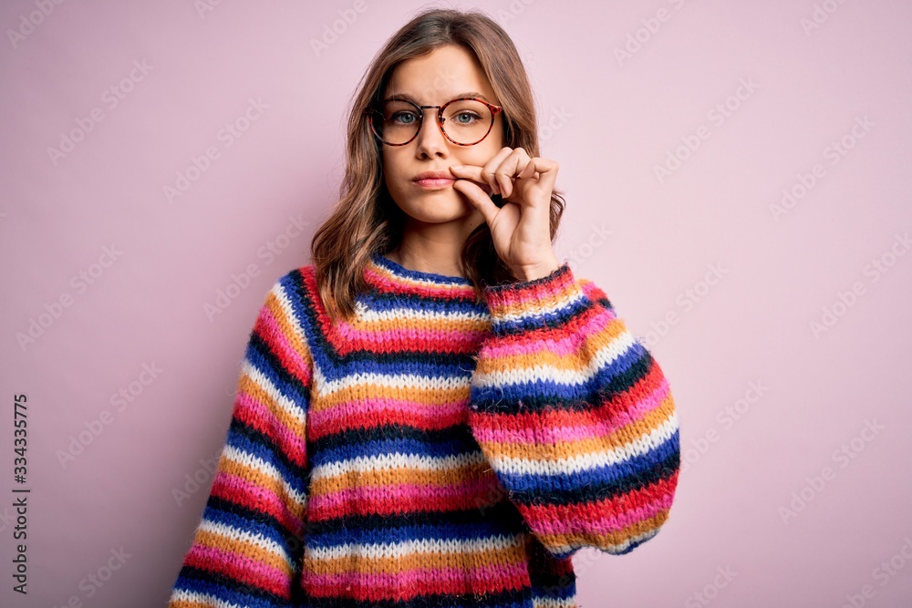 Young beautiful blonde girl wearing glasses and casual sweater over ...