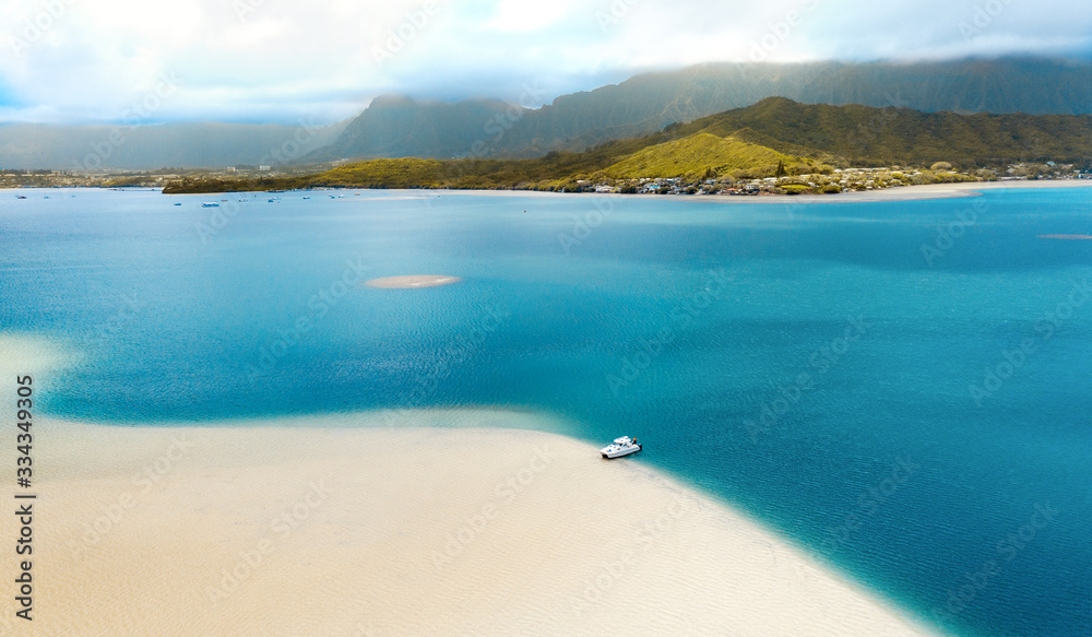 Aerial seascape view of boat in transparent blue water and white beach ...