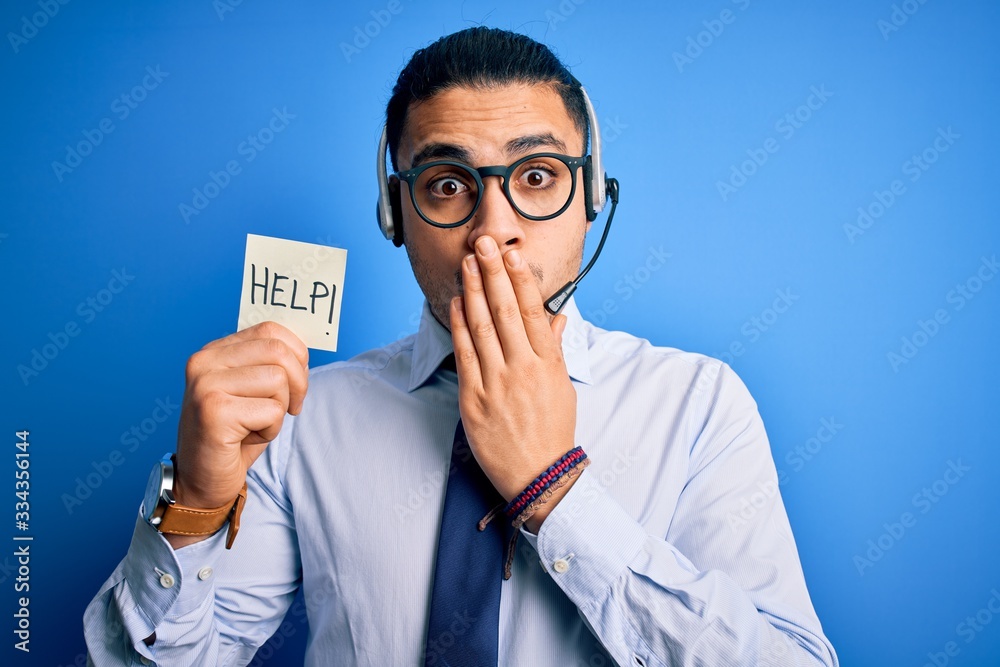 Young brazilian call center agent man overworked holding reminder paper ...