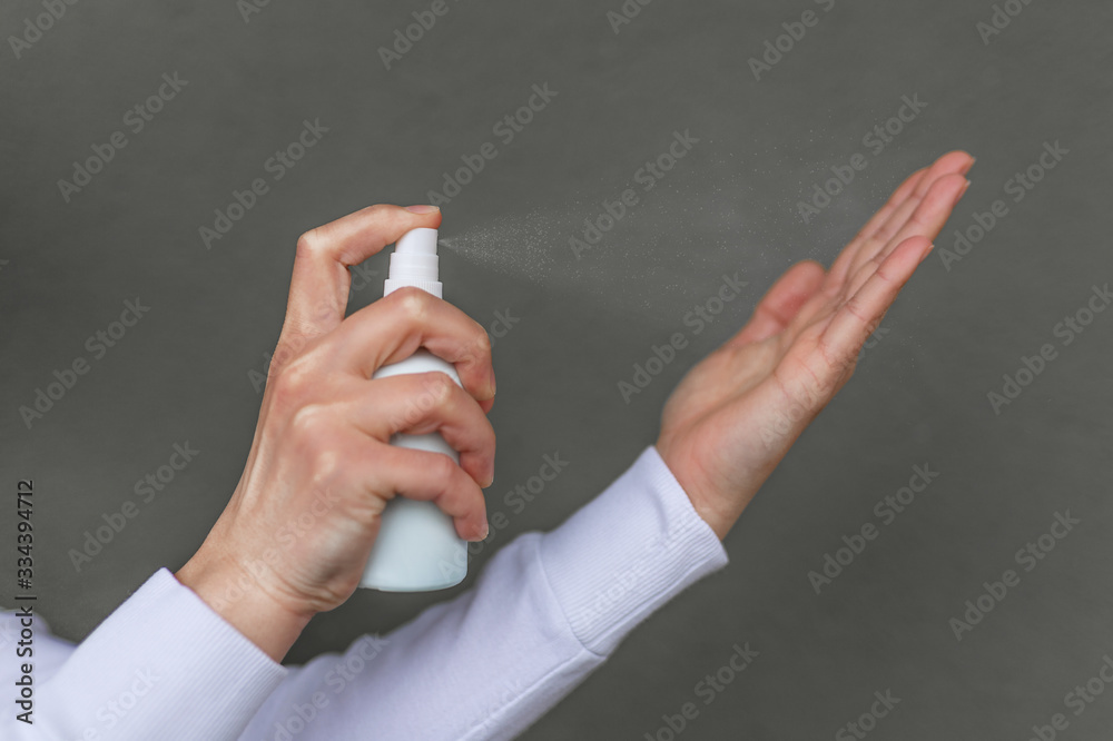 Caucasian woman wipes her hands with an alcohol-based hand-washing ...