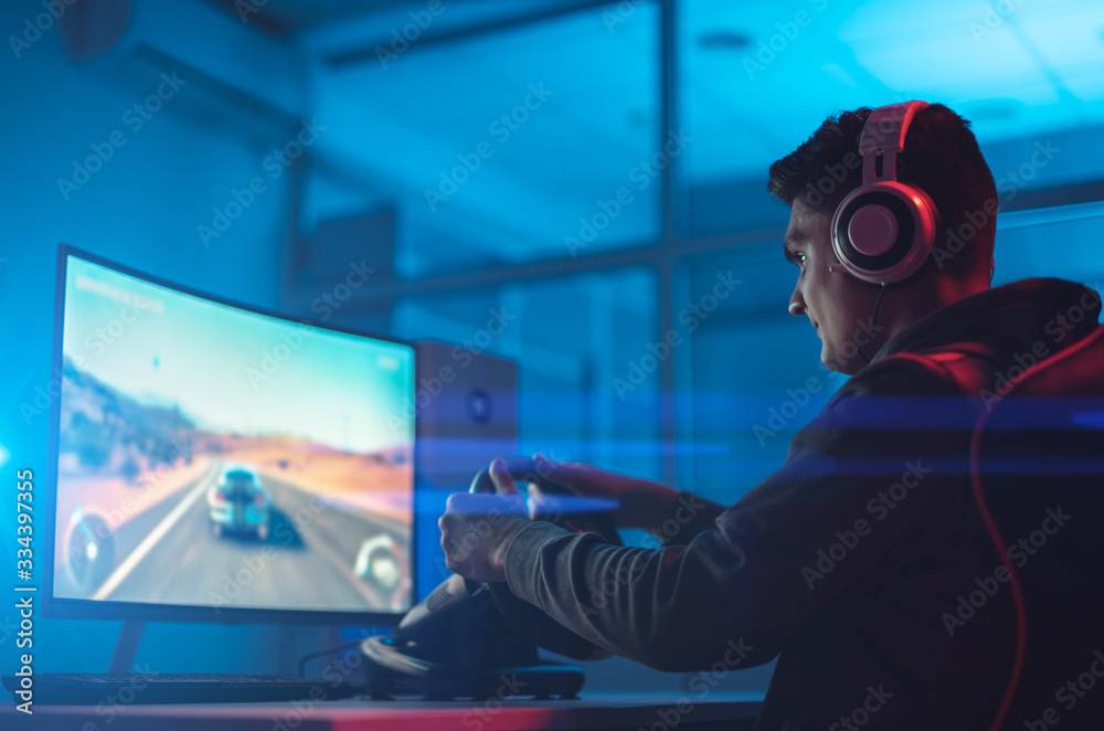 The professional gamer playing video games online in the neon room ...