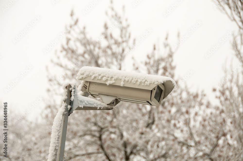 Outdoor security camera at the street in a winter. Surveillance camera ...