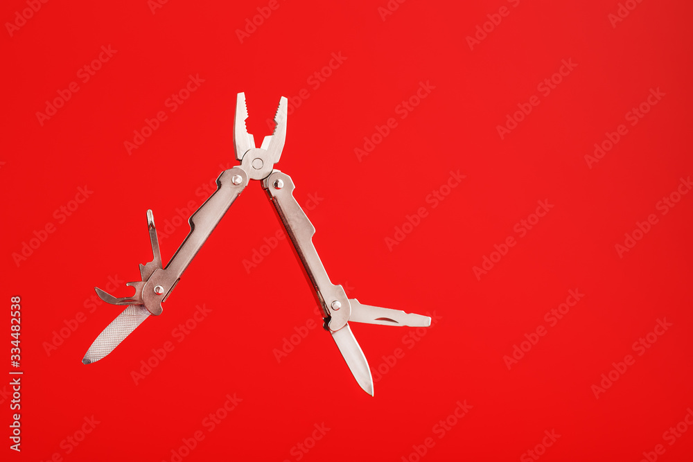Multitool is a multi-functional tool on a red background. The concept ...
