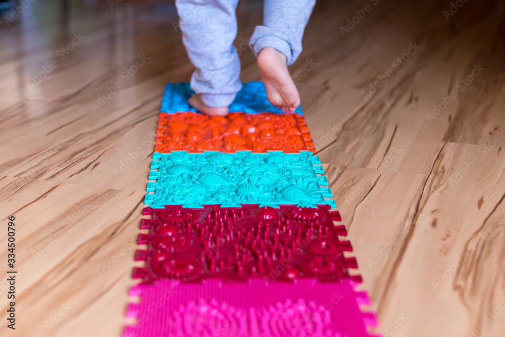 Orthopedic foot mat for child gymnastic. Small children with a flat ...