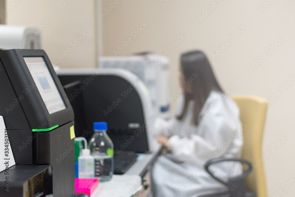 DNA sequencing in science room with blur background of female scientist ...