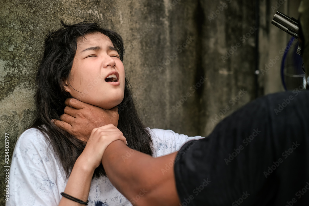 Young Asia woman was strangled by a thief and robber point the gun at ...