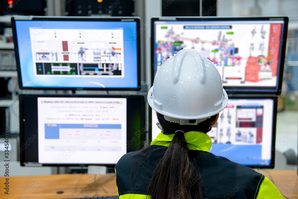 Inside the large Industry Factory Female Computer Engineer Works on ...